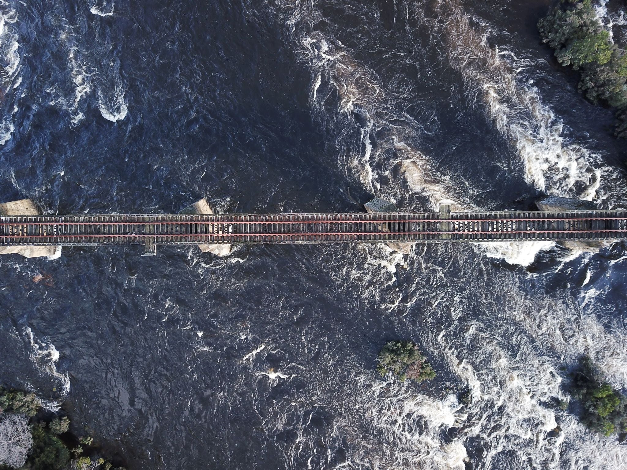 Aerial view of a train track across a river in Tasmania, Australia ...